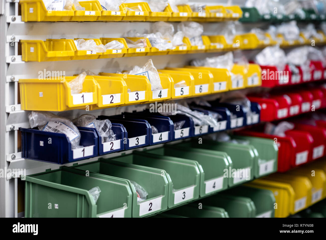 Colorful plastic cells in the warehouse with car parts Stock Photo - Alamy