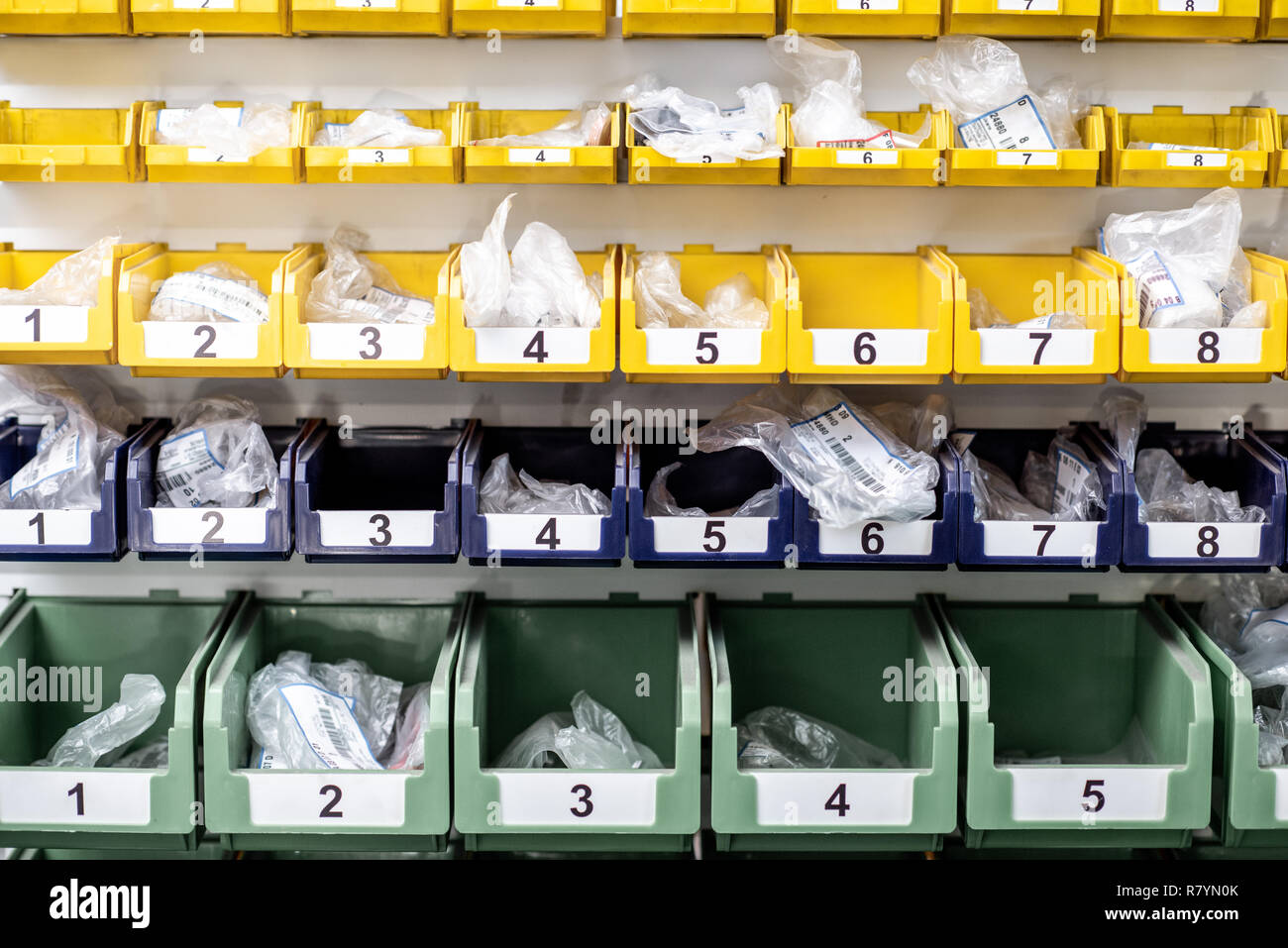Colorful plastic cells in the warehouse with car parts Stock Photo - Alamy