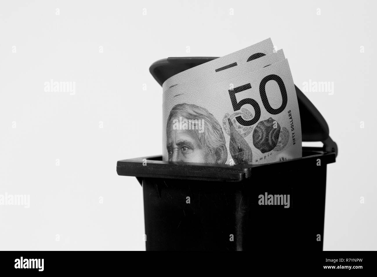 Australian fifty dollar notes in a trash bin in black and white Stock ...