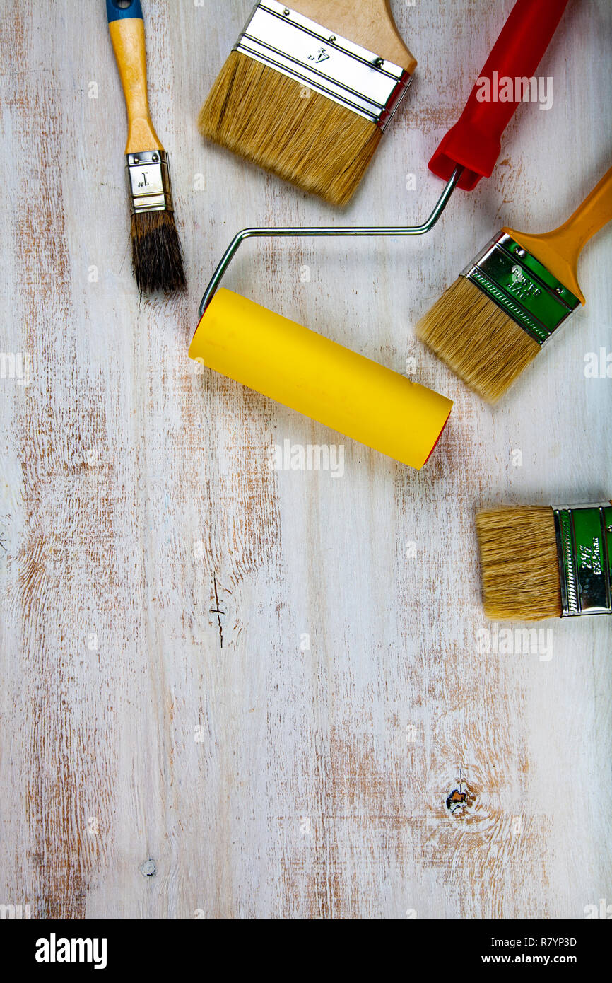 Roller and brush on the table. Items for home or office renovation ...