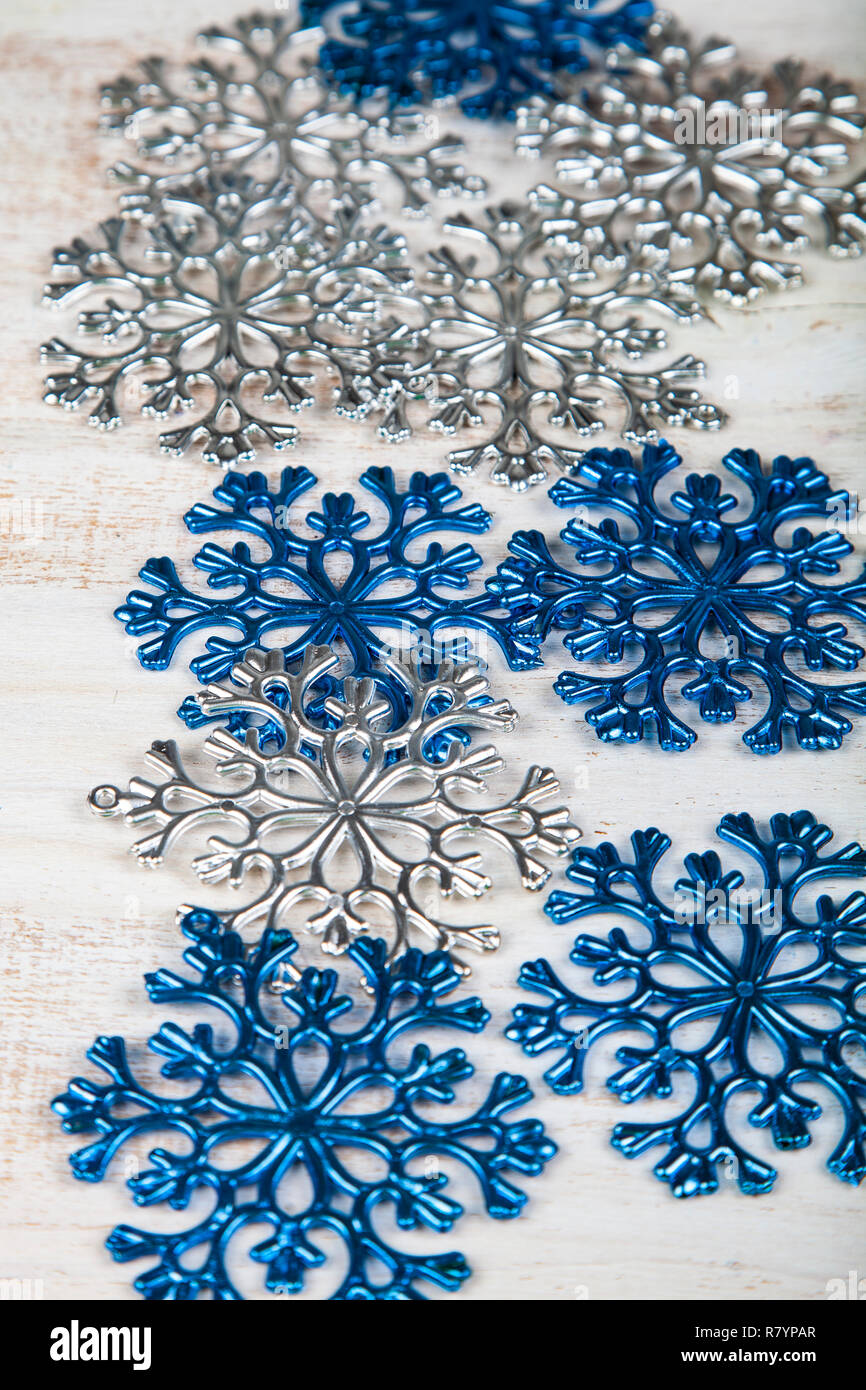 Blue and silver snowflakes on a wooden background. Christmas decor ...