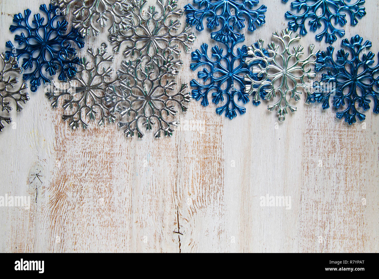 Border of blue and silver snowflakes on a wooden background. Christmas ...