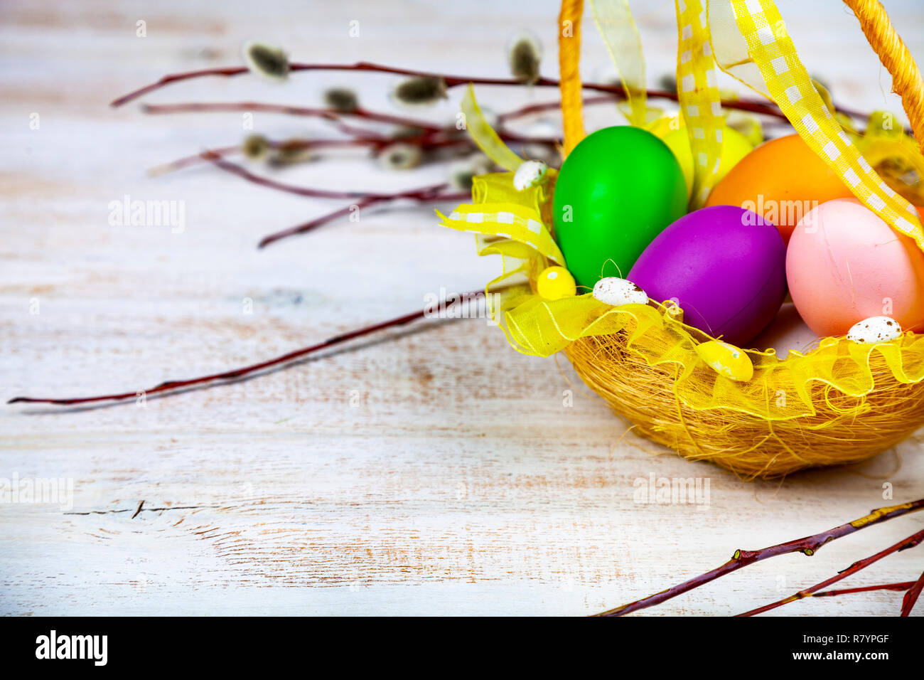 Easter still life with Easter eggs in a basket and willow. Easter ...