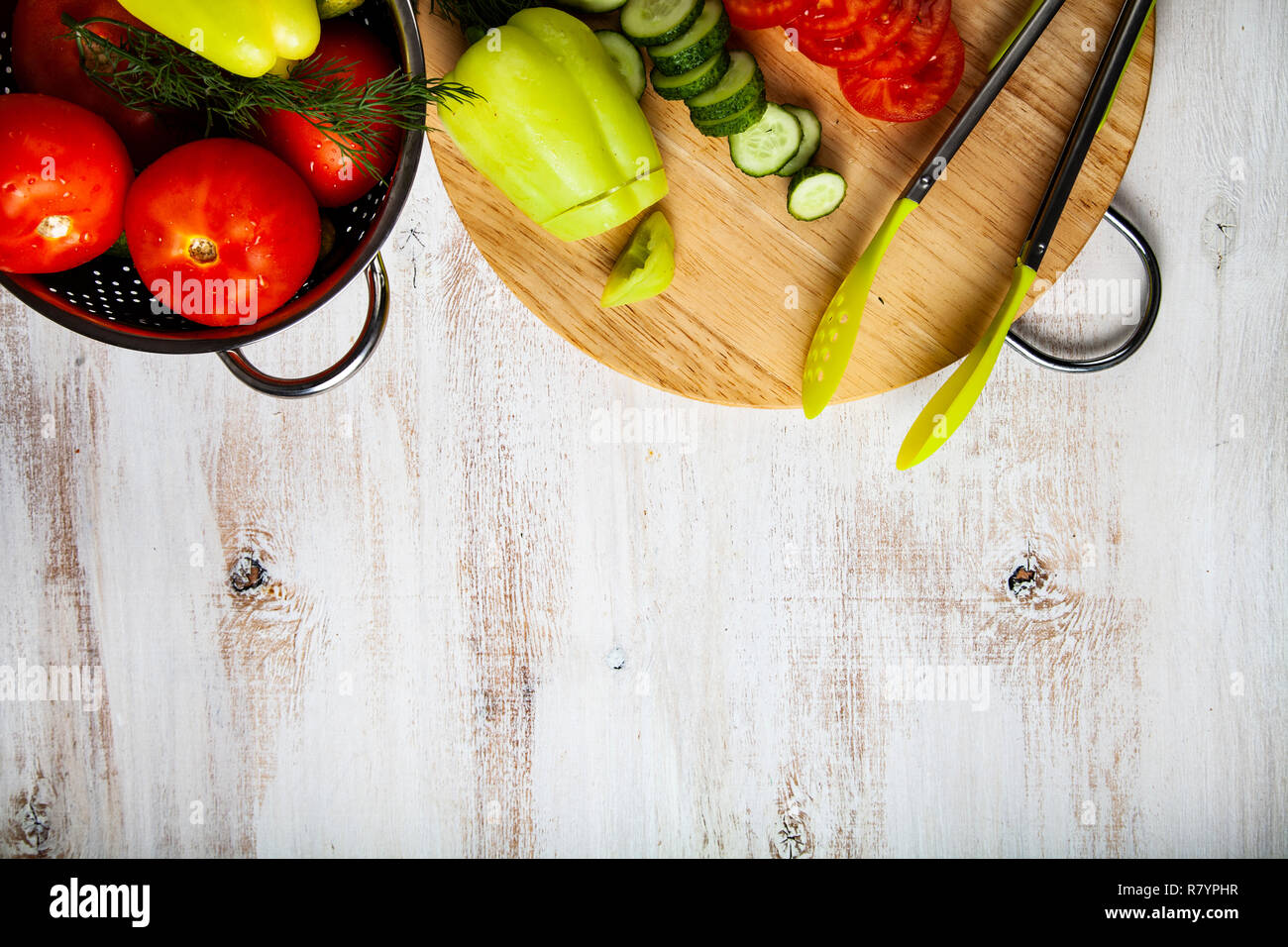 Vegetables for salad and cutting board on the table. Preparation of ...