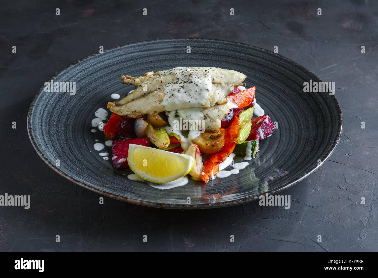 Fried fish fillet with grilled beetroot, carrot, bell pepper, zucchini ...