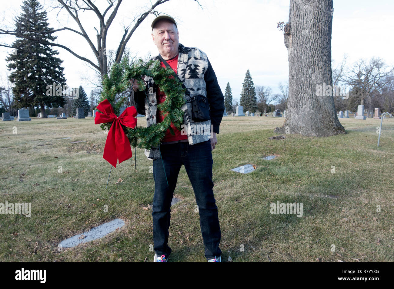 Infamous photographer Steve Skjold holding wreath at his parents grave ...
