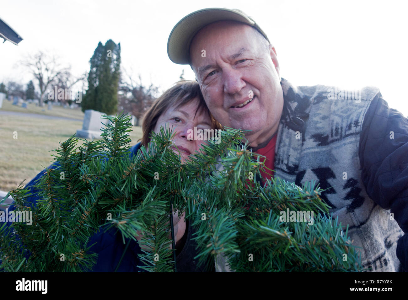 Photographers Mary and Steve Skjold holding wreath to honor parents at ...