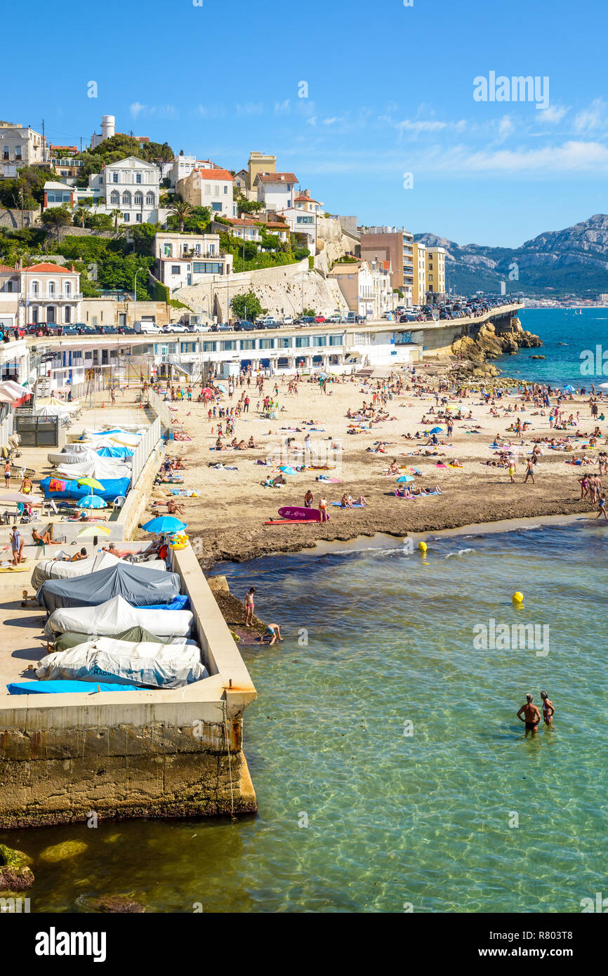 People sunbathing and swimming on the Prophet beach in Marseille, a ...
