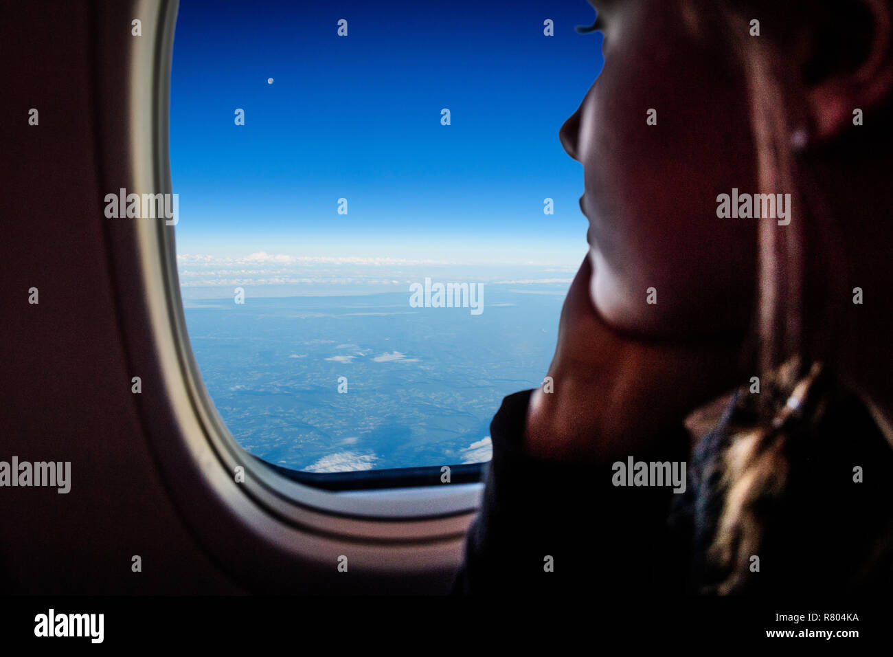 Woman looking through window of plane hi-res stock photography and ...