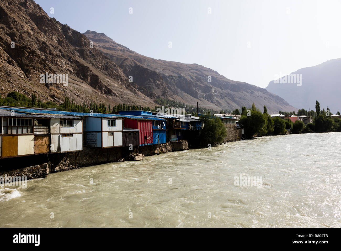 Gunt River with houses in Khorog in the Wakhan valley in Tajikistan ...
