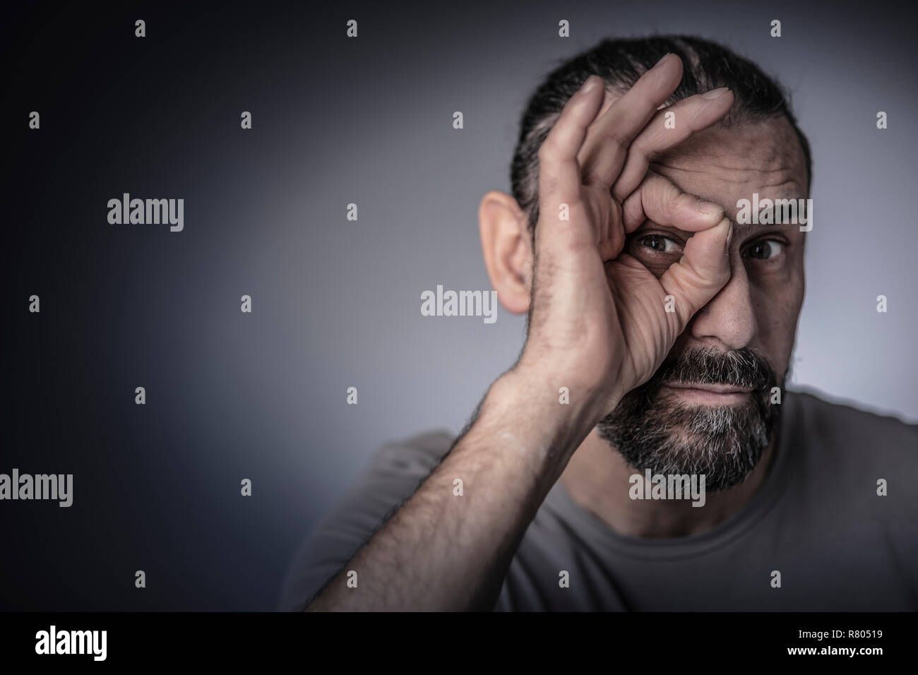 man look throught circle made by his finger Stock Photo - Alamy
