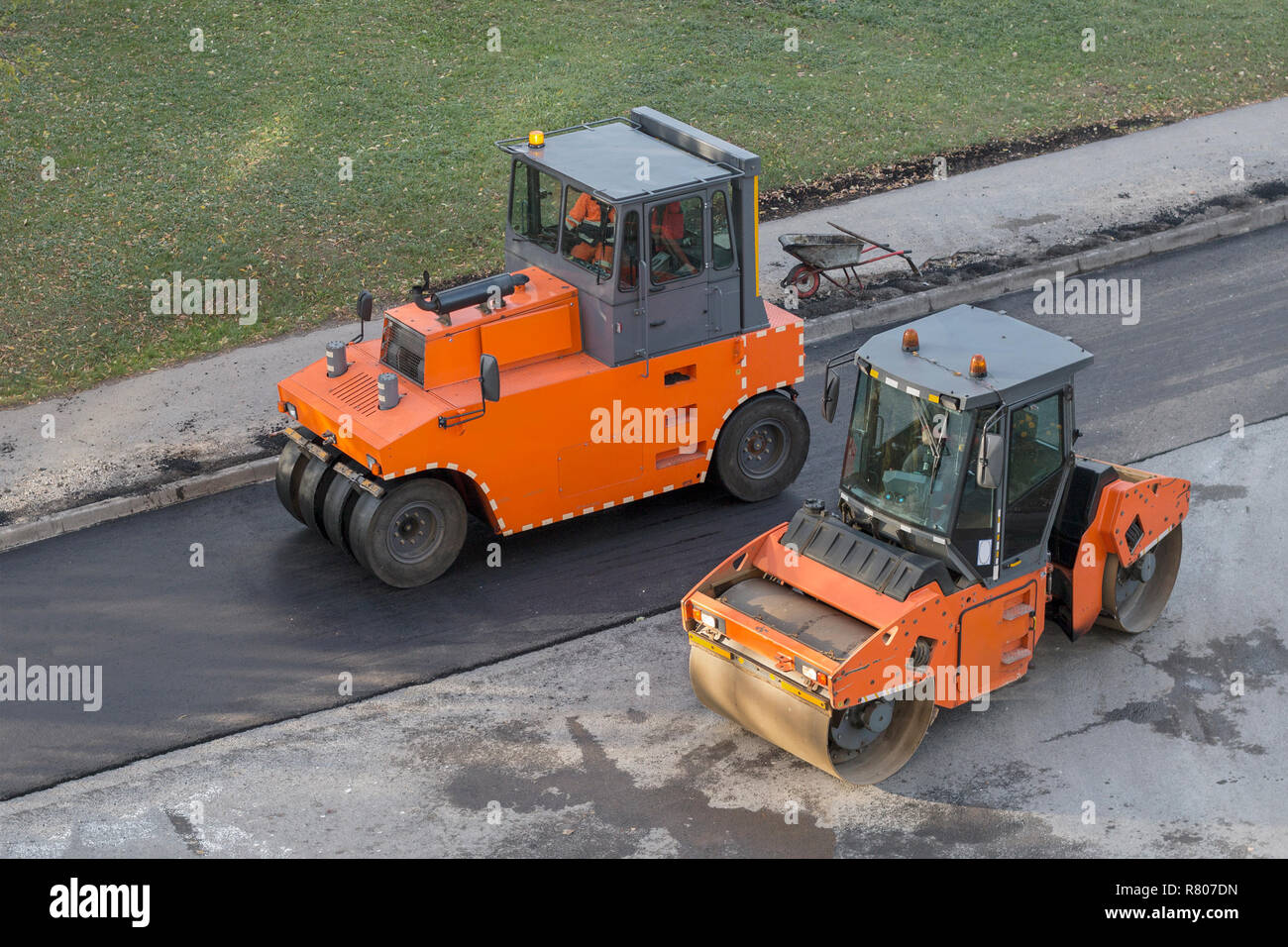Road construction working. Two roller compactor machines press new ...