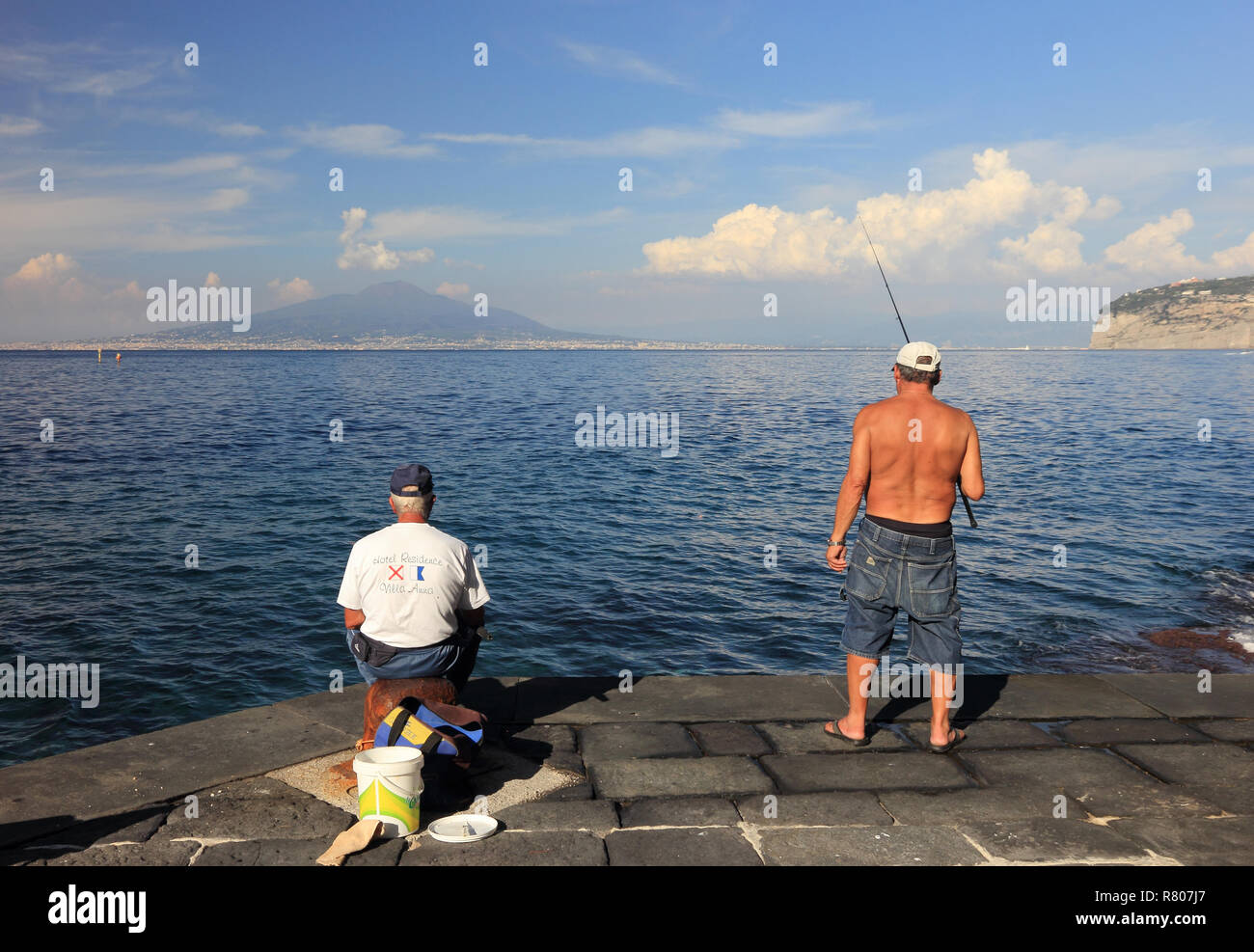 Men fishing in Bay of Naples Stock Photo - Alamy