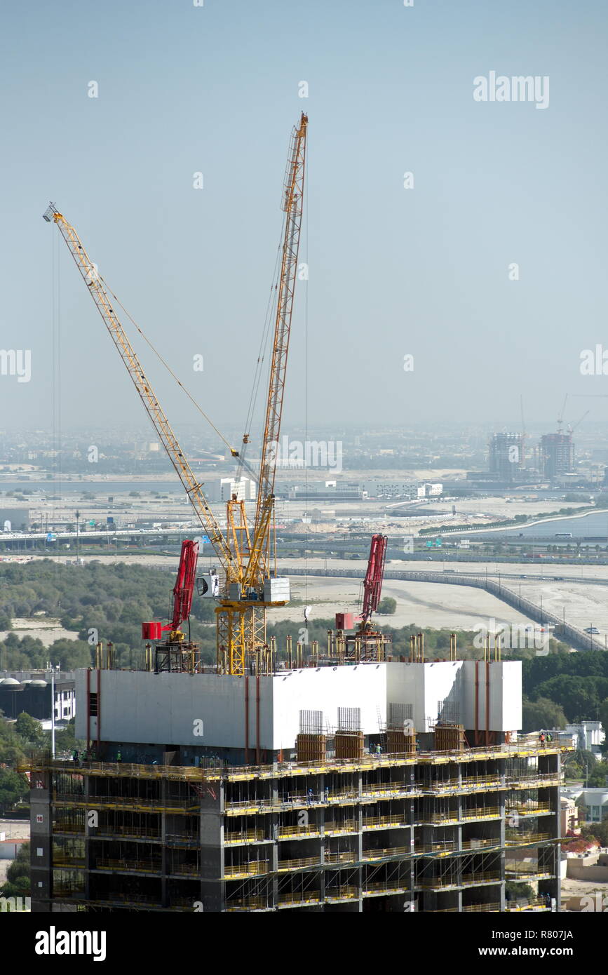 Aerial view of under construction building with cranes from downtown ...