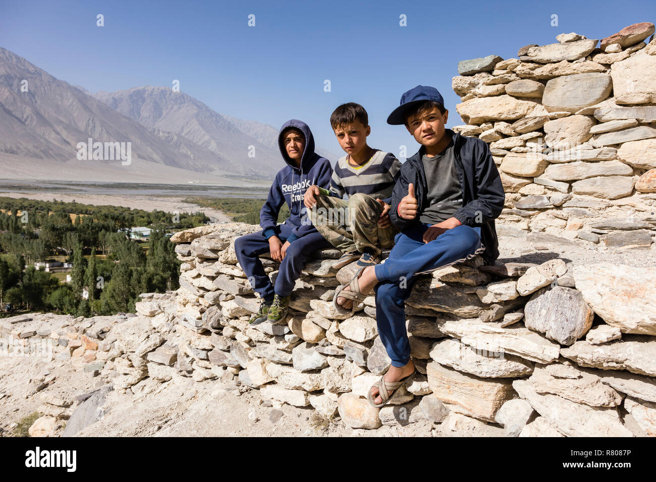 Vrang, Tajikistan August 24 2018: Three boys are sitting in Vrang on a ...