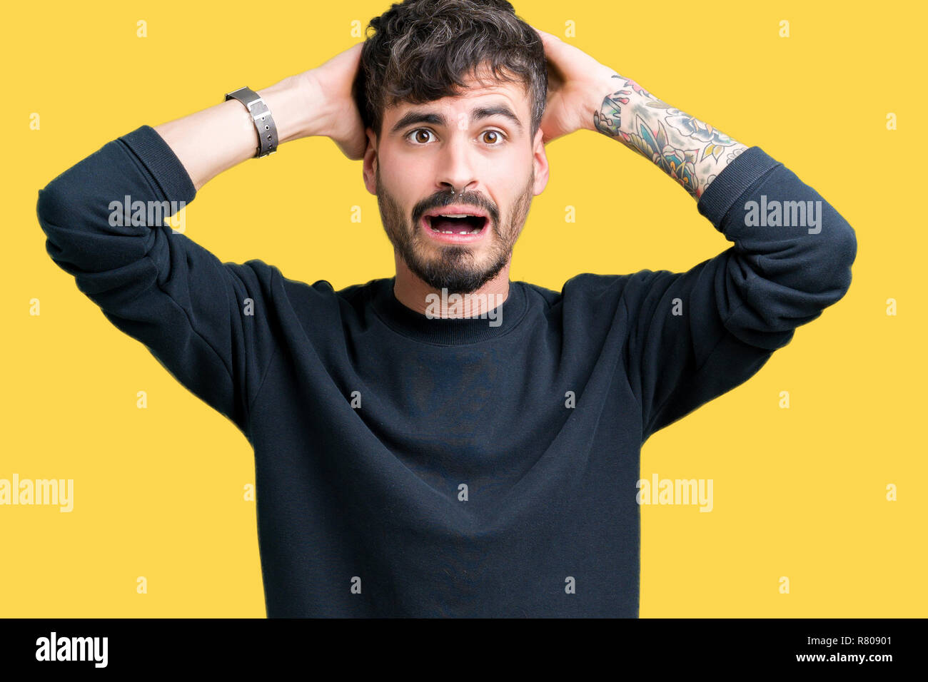 Young handsome man over isolated background Crazy and scared with hands ...