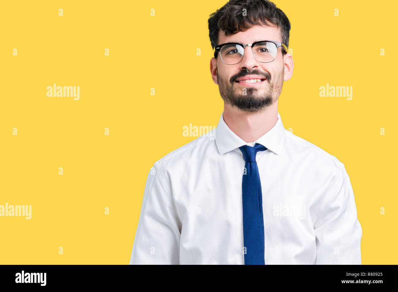Young handsome business man wearing glasses over isolated background ...