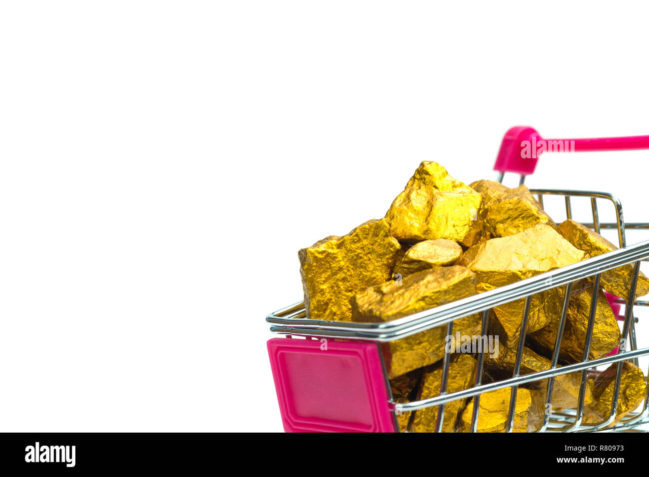 Pile of gold nuggets or gold ore in shopping cart or supermarket ...