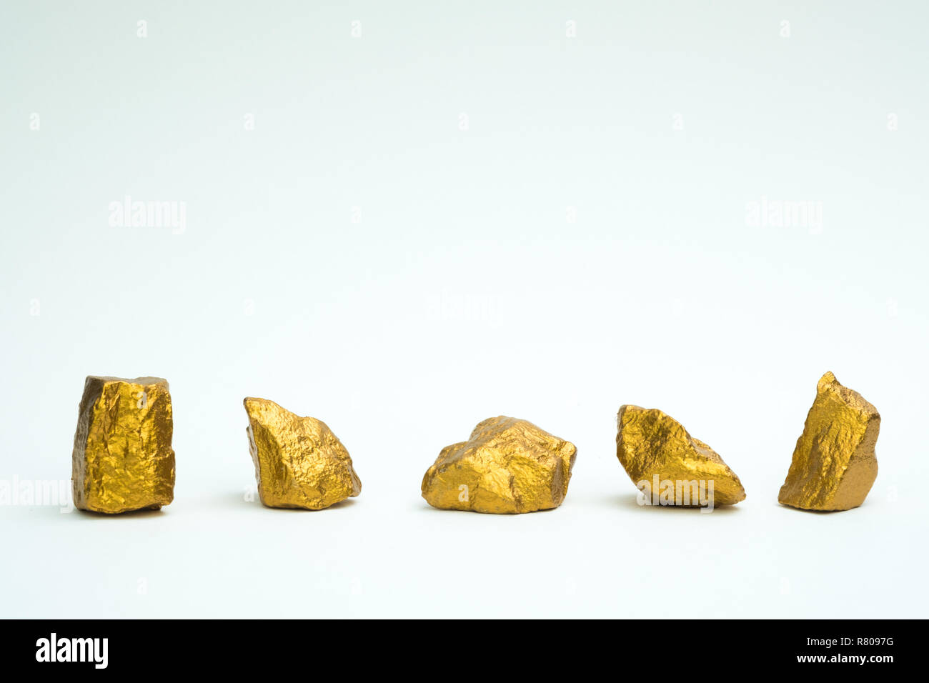 A pile of gold nuggets or gold ore on white background, precious stone ...
