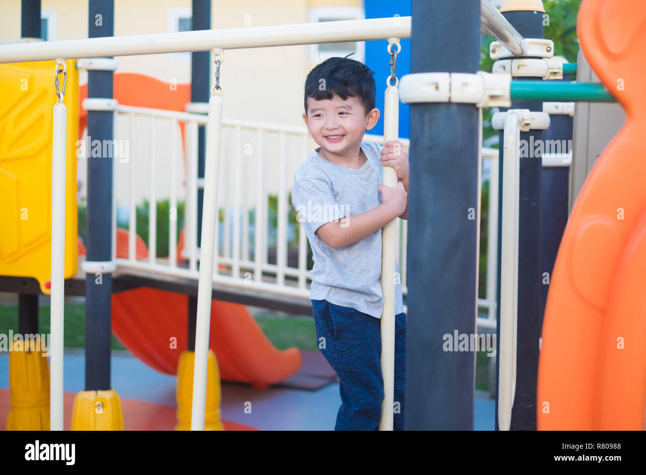Asian kid playing at the playground under the sunlight in summer, Happy ...