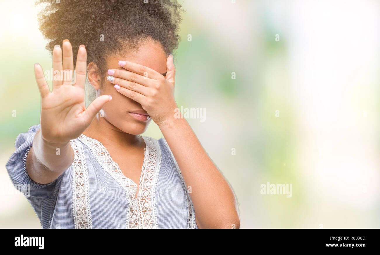 Young afro american woman over isolated background covering eyes with ...