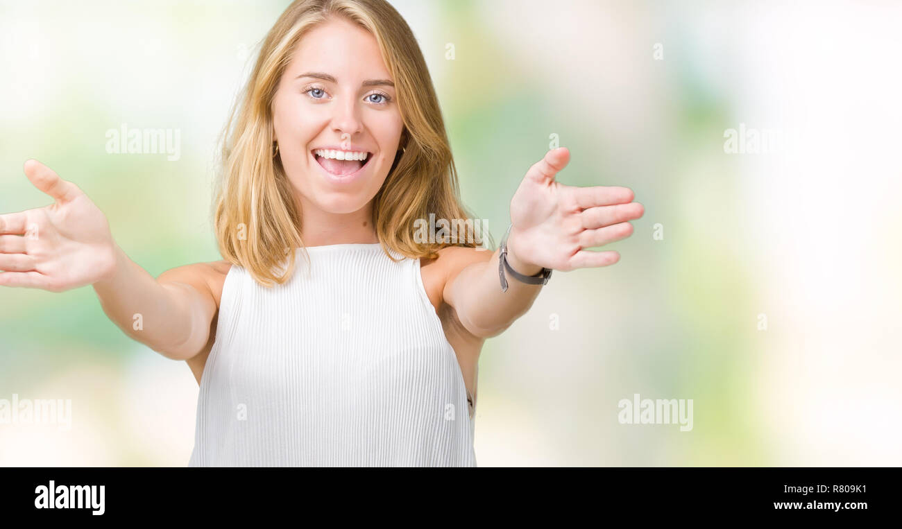 Beautiful young elegant woman over isolated background looking at the ...