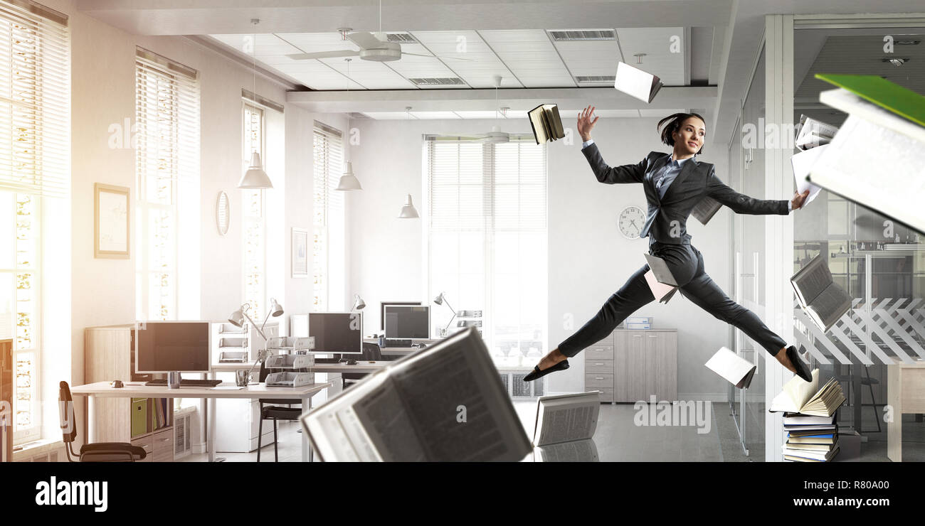 Dancing businesswoman in office. Mixed media Stock Photo - Alamy
