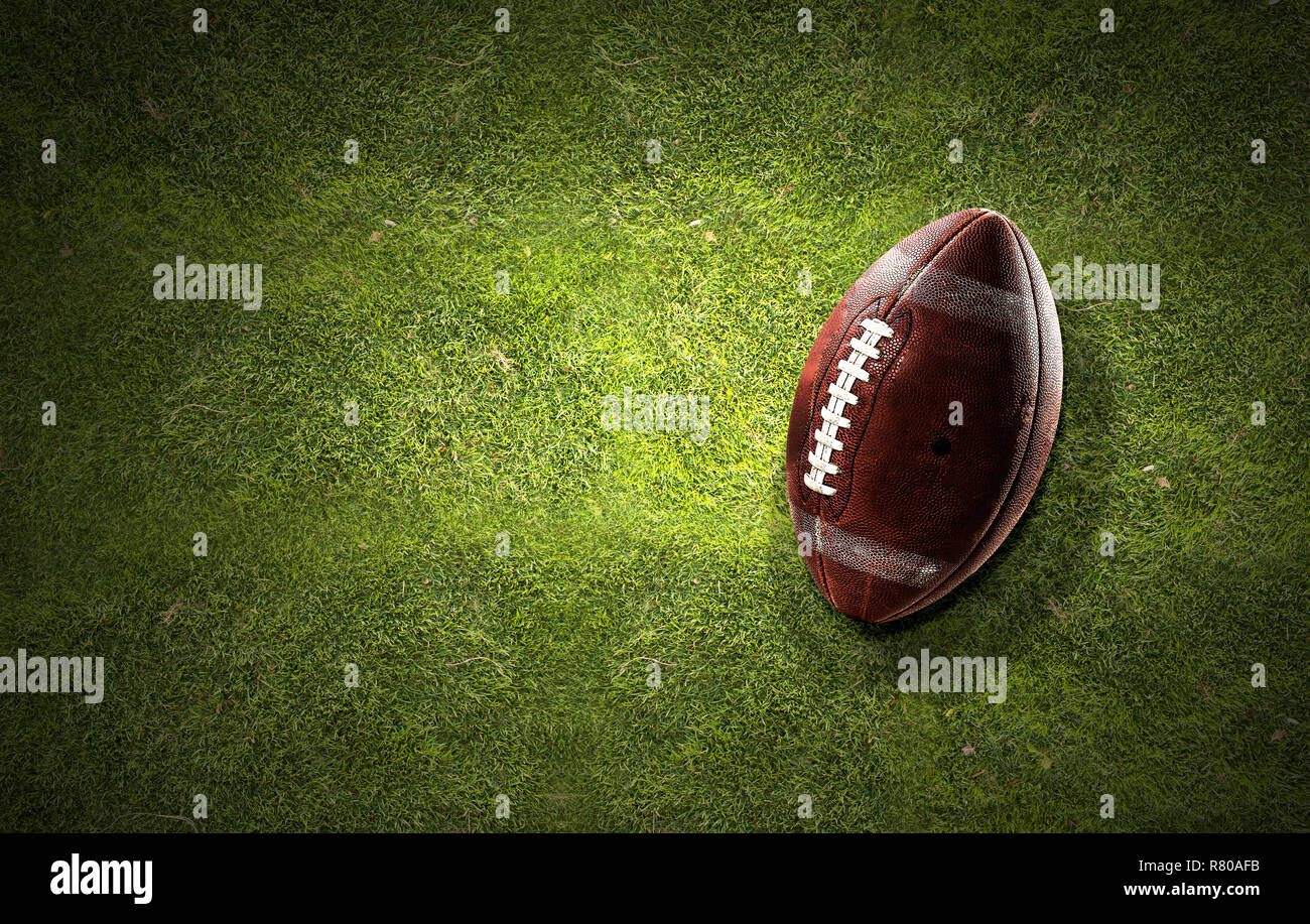 American rugby ball on grass hi-res stock photography and images - Alamy
