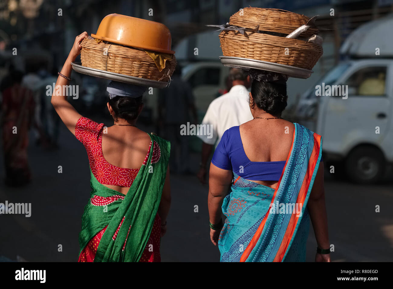 In the early morning light, two traditionally clad Indian women in ...