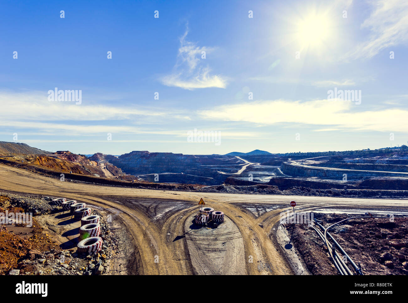 Aerial view of opencast mining quarry with sun and blue sky.This area ...