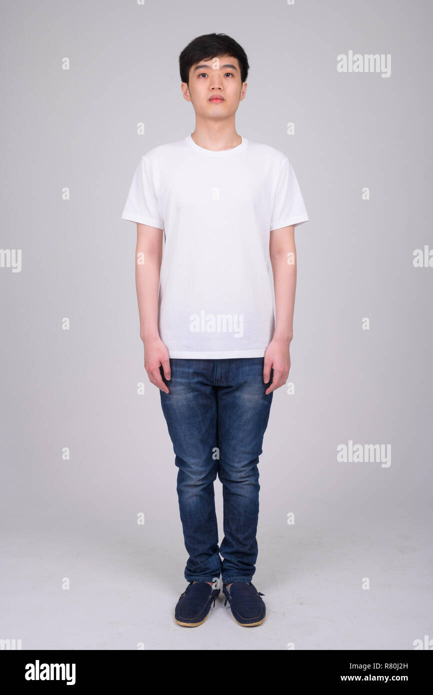Full body shot of young Asian man standing Stock Photo - Alamy