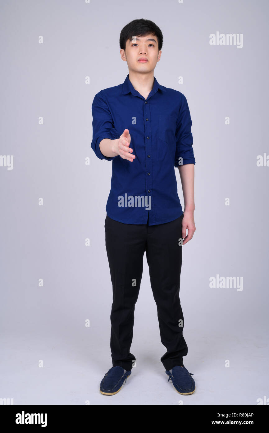 Full body shot of young Asian businessman giving handshake Stock Photo ...