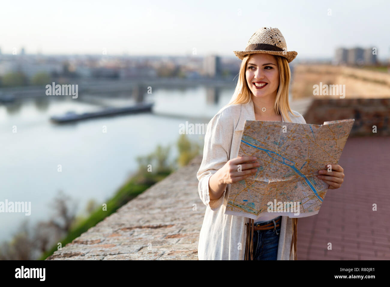Tourist woman looking at map and exploring city Stock Photo - Alamy