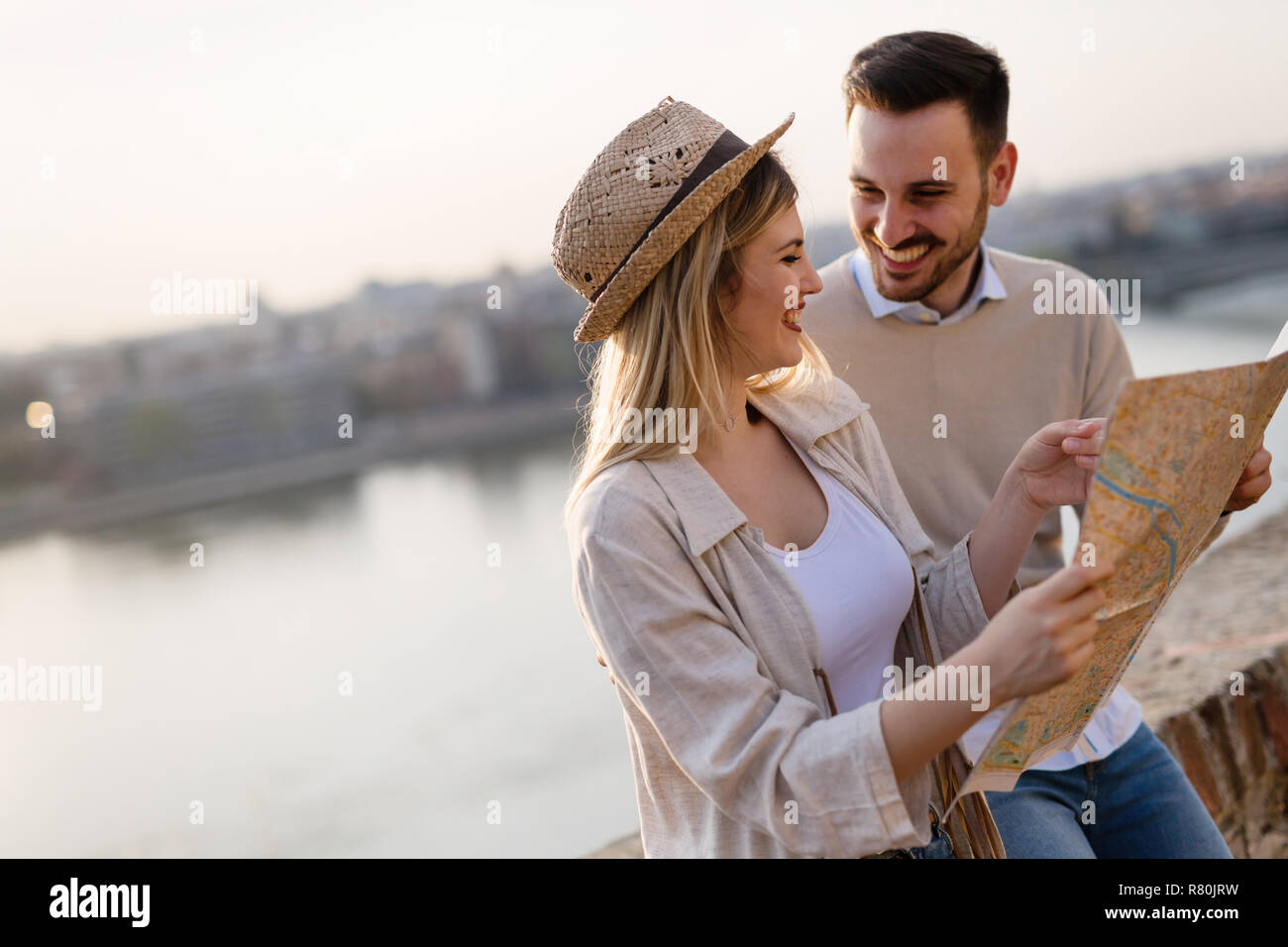 Tourist young couple using map as guide Stock Photo - Alamy