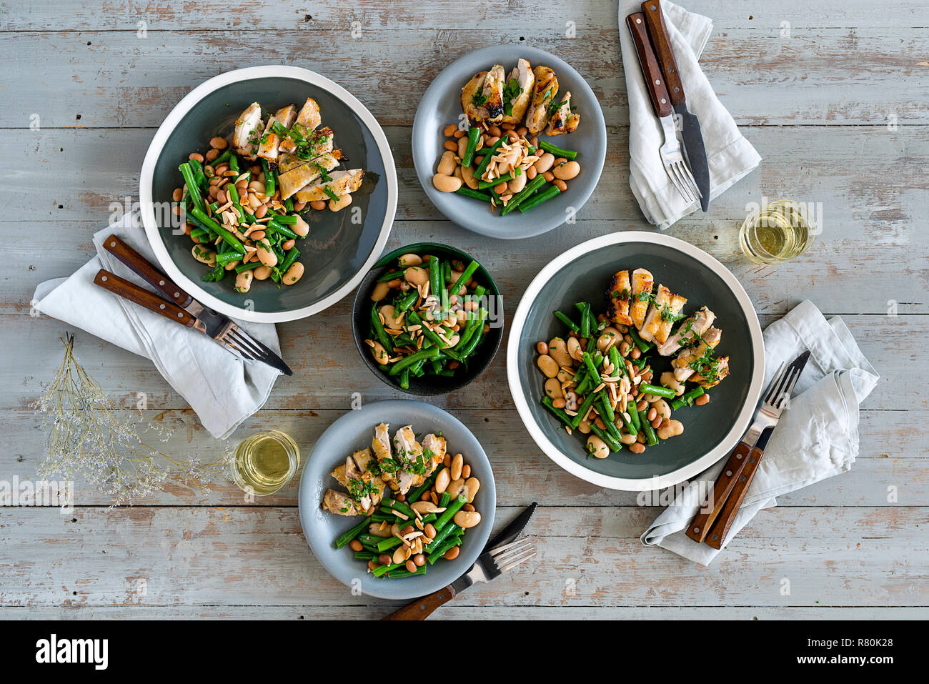 Top down styled food shoot of chicken and vegetable dish on rustic ...