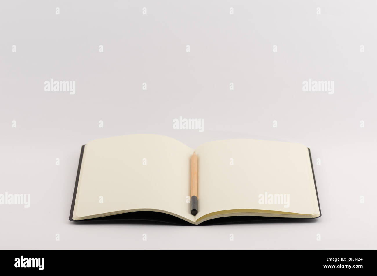 open blank copybook with pencil backdrop - white background Stock Photo ...