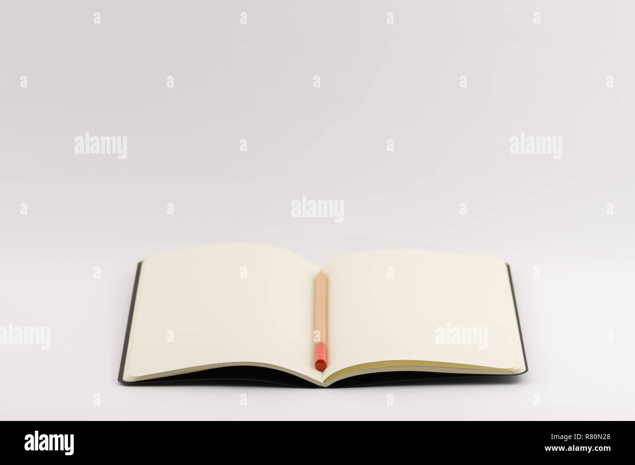 open blank copybook with pencil backdrop - white background Stock Photo ...