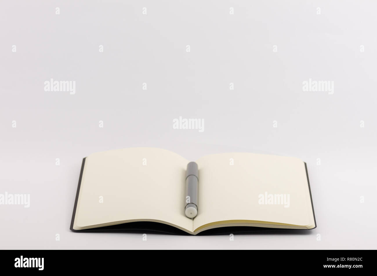open blank copybook with pencil backdrop - white background Stock Photo ...