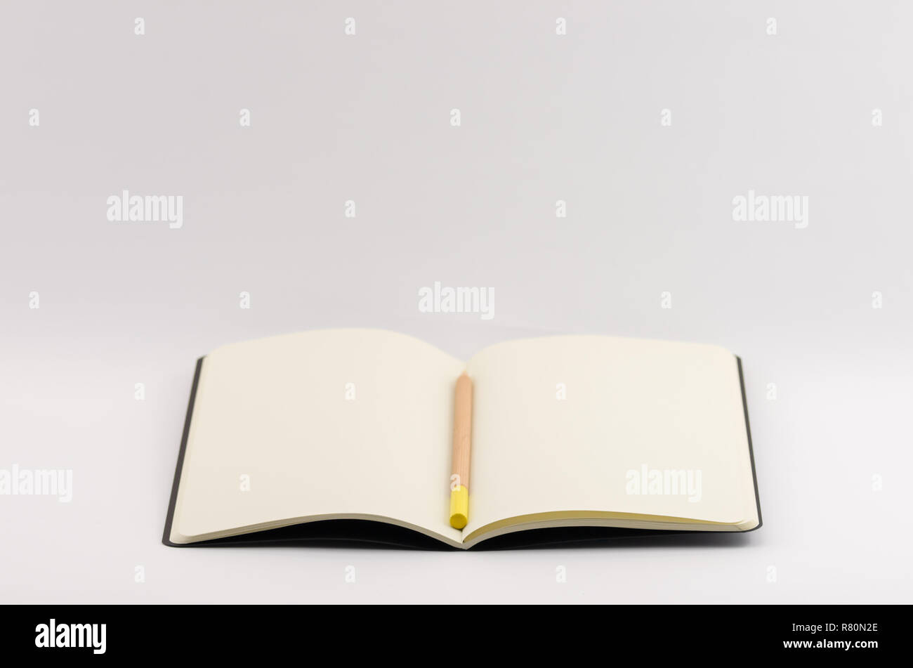 open blank copybook with pencil backdrop - white background Stock Photo ...