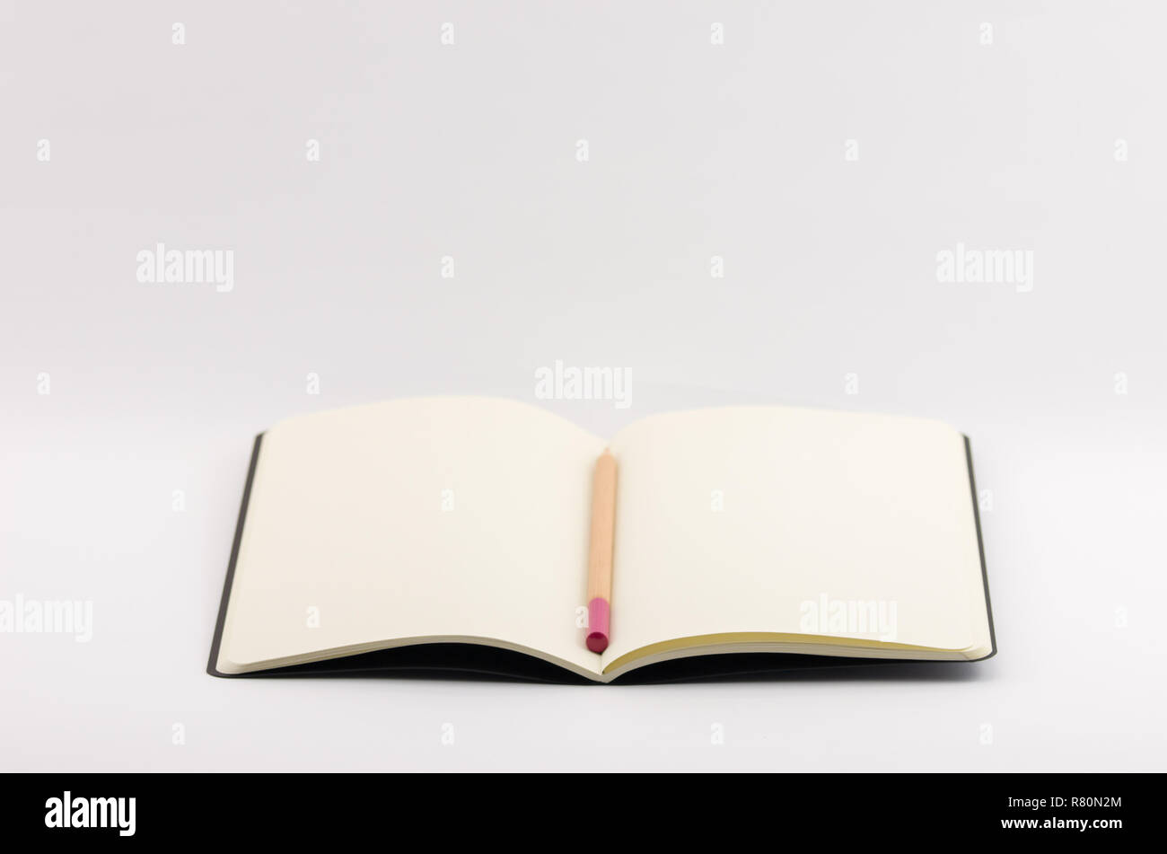 open blank copybook with pencil backdrop - white background Stock Photo ...