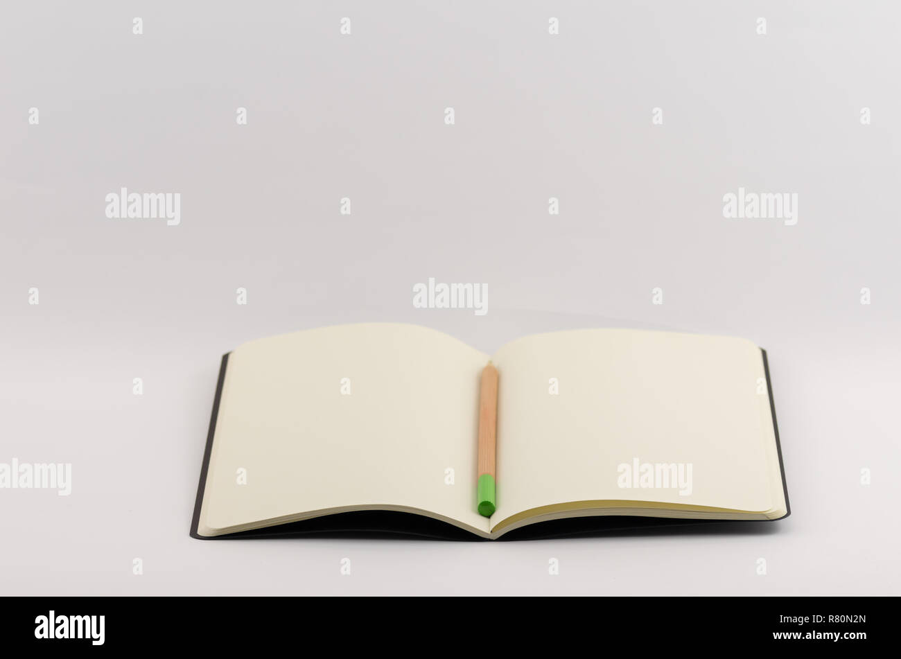 open blank copybook with pencil backdrop - white background Stock Photo ...