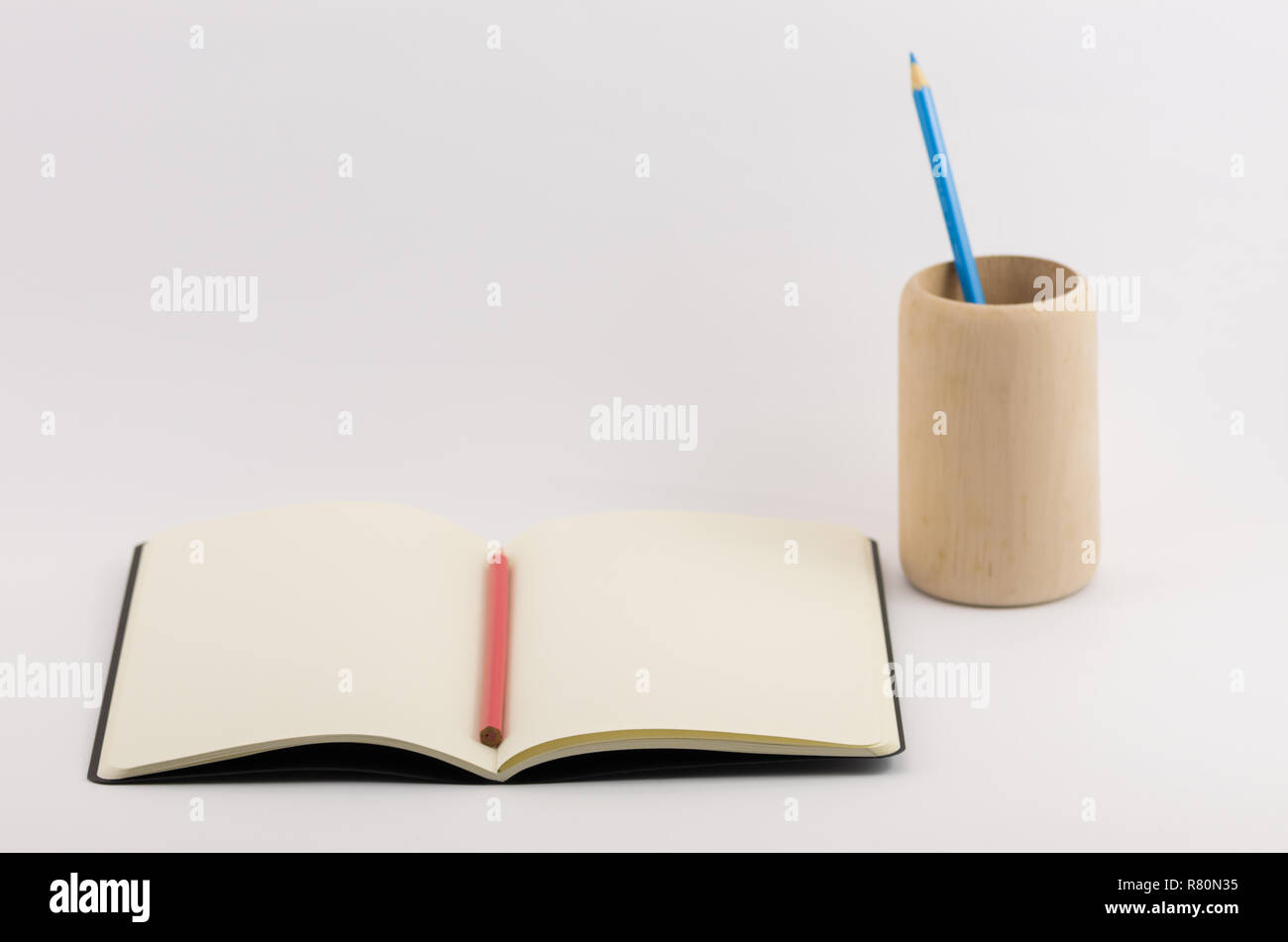 open blank copybook with pencil backdrop - white background Stock Photo ...