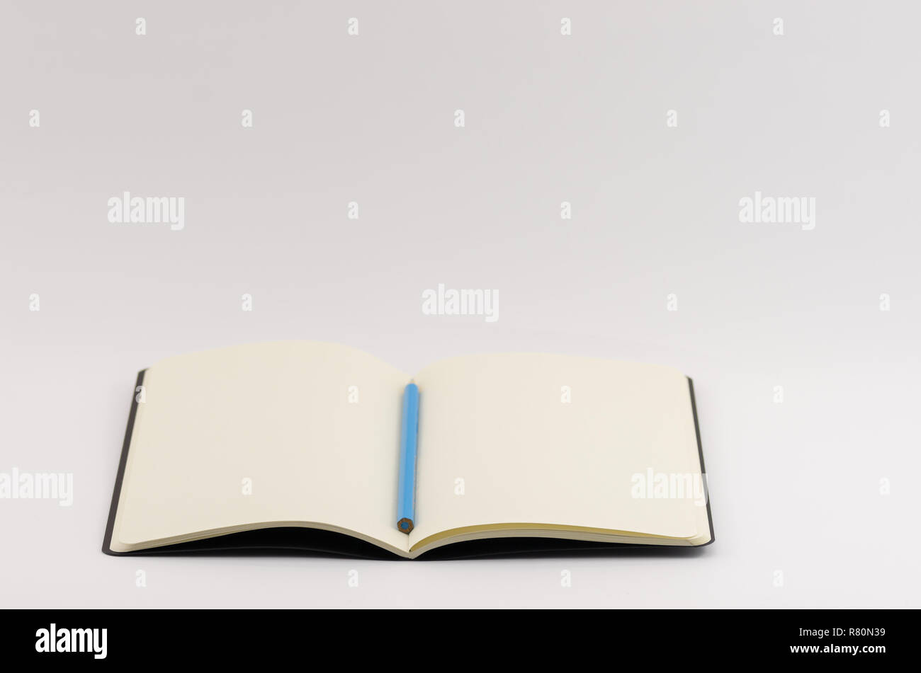 open blank copybook with pencil backdrop - white background Stock Photo ...