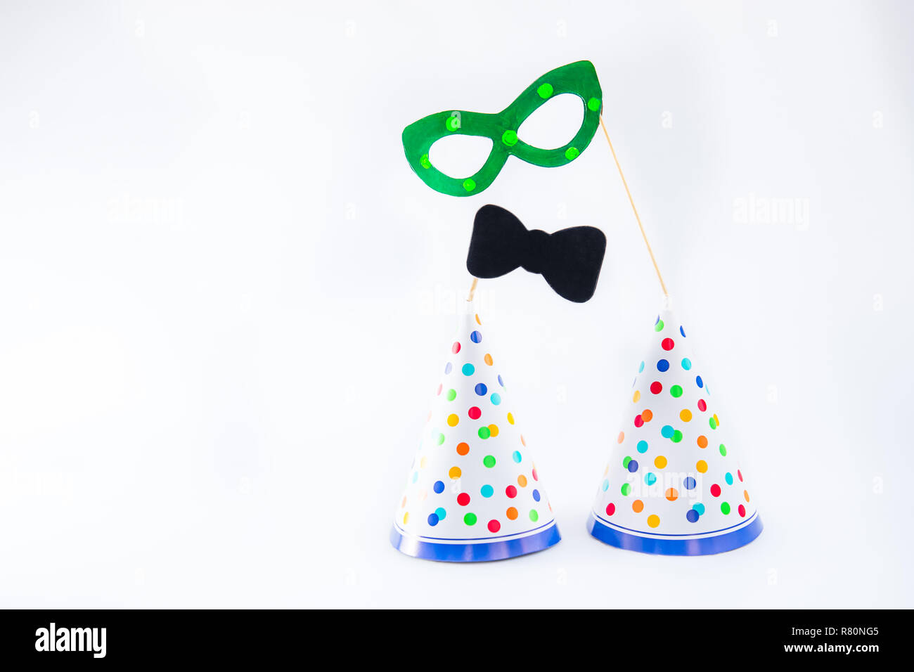 Carnival caps and funny masks on a white background isolated. Party ...