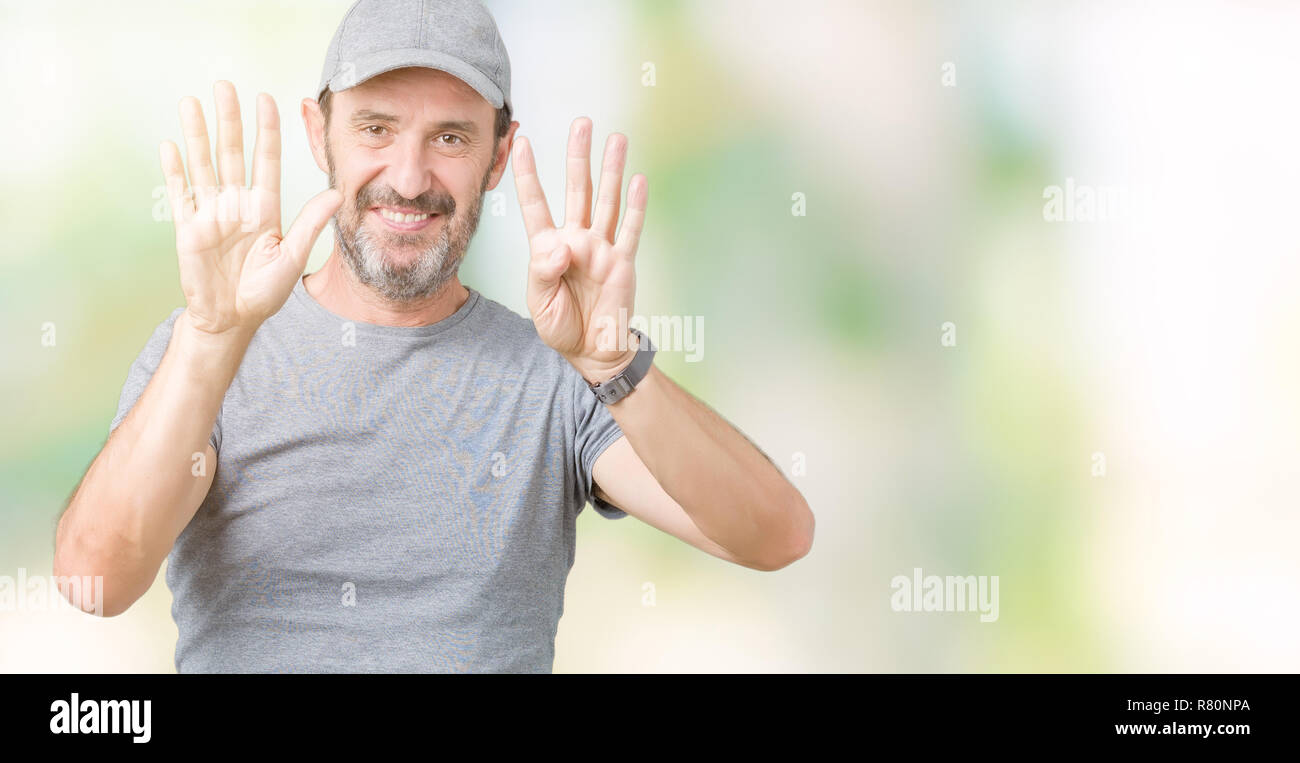 Handsome middle age hoary senior man wearing sport cap over isolated ...