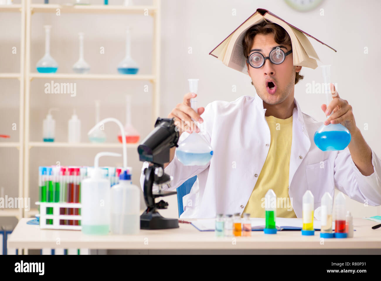 Funny crazy chemist doing experiments and tests Stock Photo - Alamy