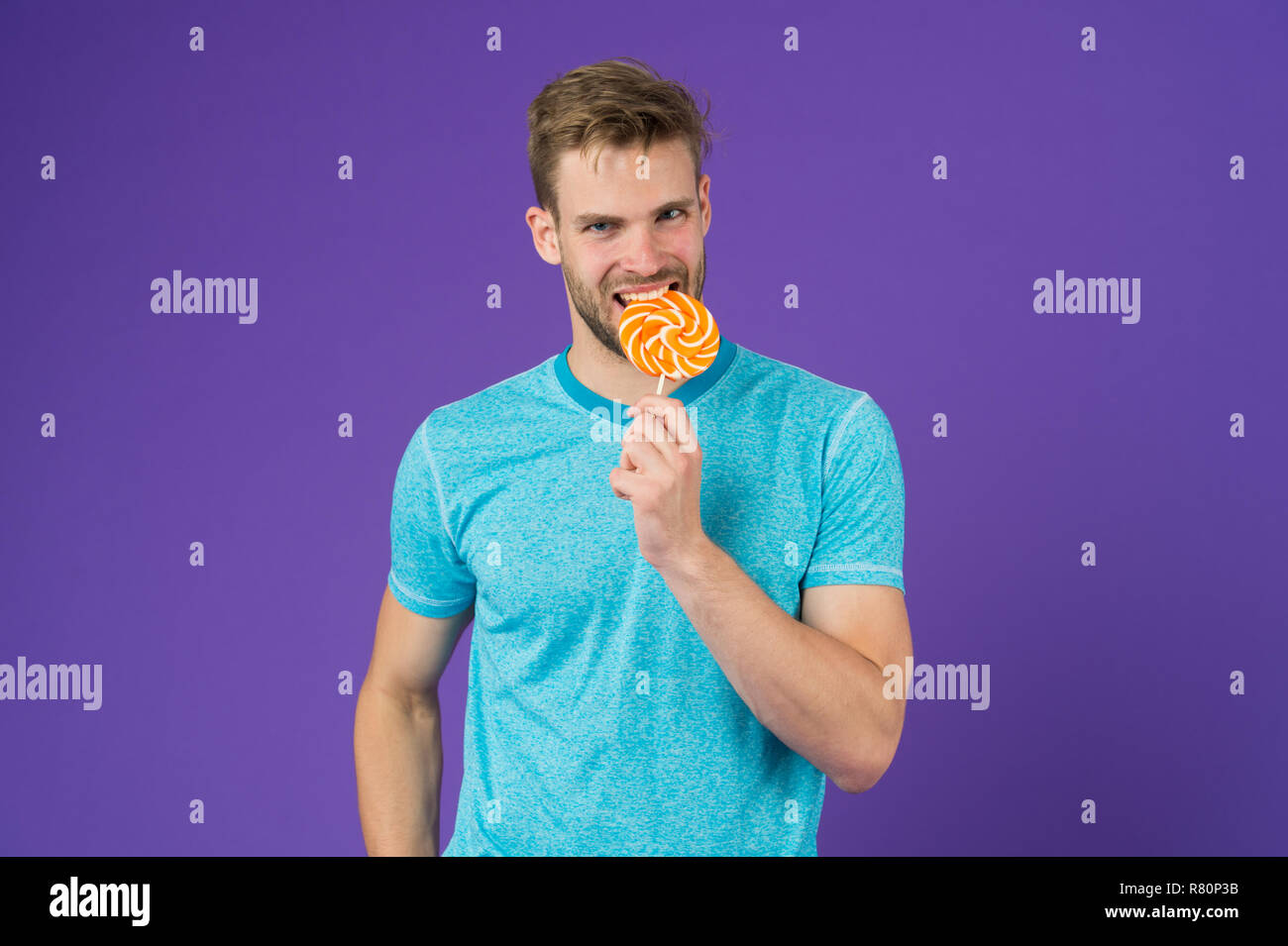 Man bearded adult likes lollipop. Sweet tooth concept. Sugar harmful ...