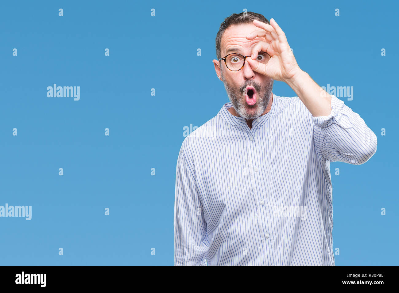 Middle age hoary senior man wearing glasses over isolated background ...