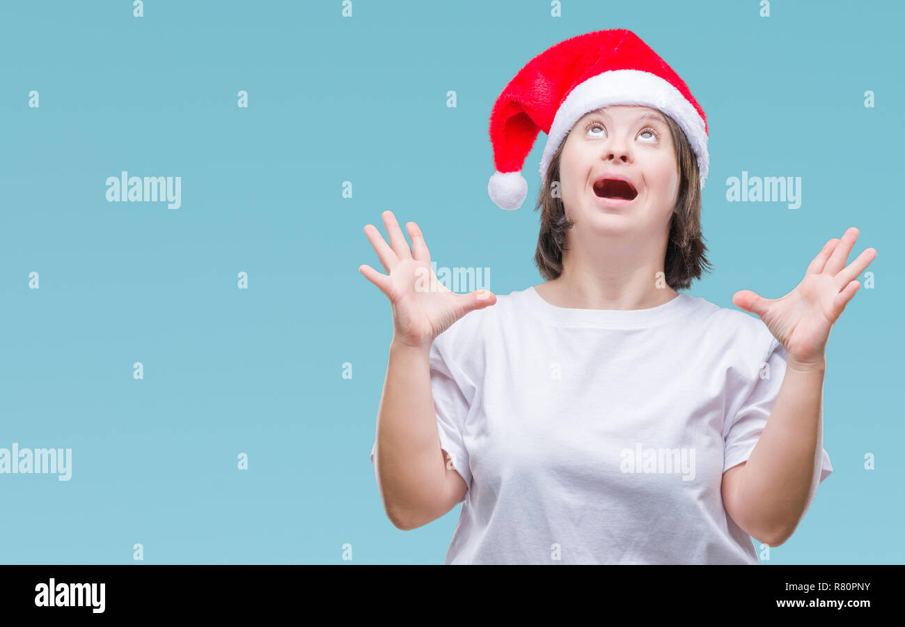 Young adult woman with down syndrome wearing christmas hat over ...