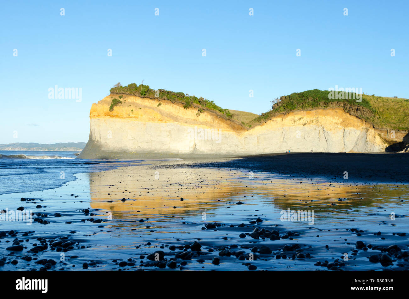 Cliffs reflected in wet beach, Onaero, Taranaki, North Island, New ...